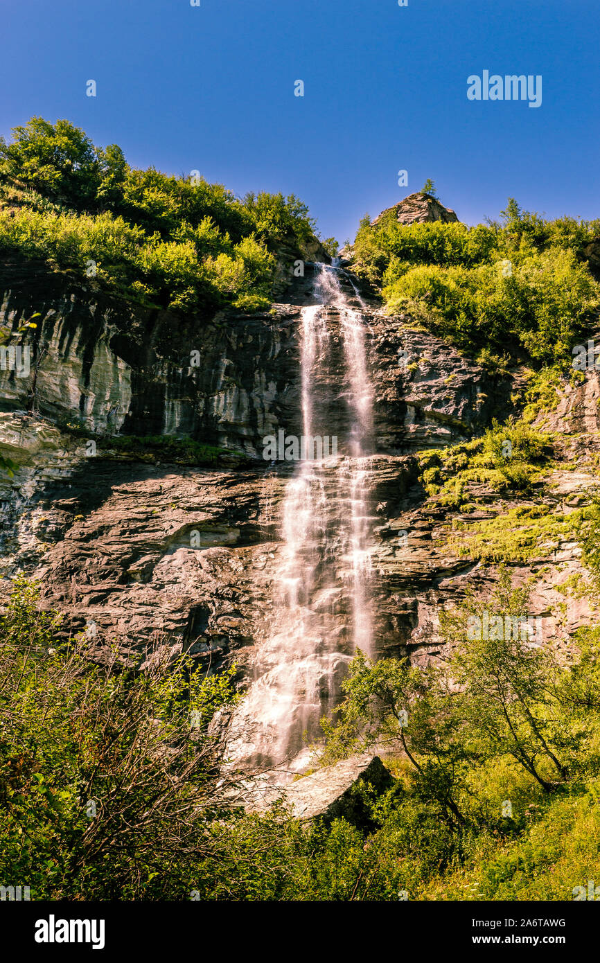 Small waterfall in Pennine Alps on a bright sunny day in summer. Val d ...