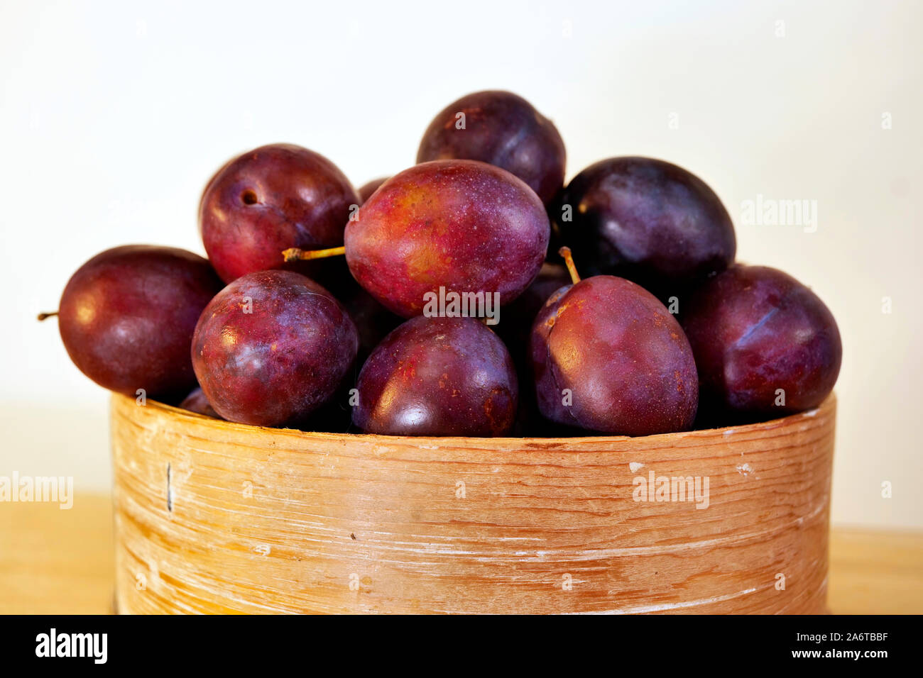 Ripe plump and juicy plums on a white background Stock Photo - Alamy