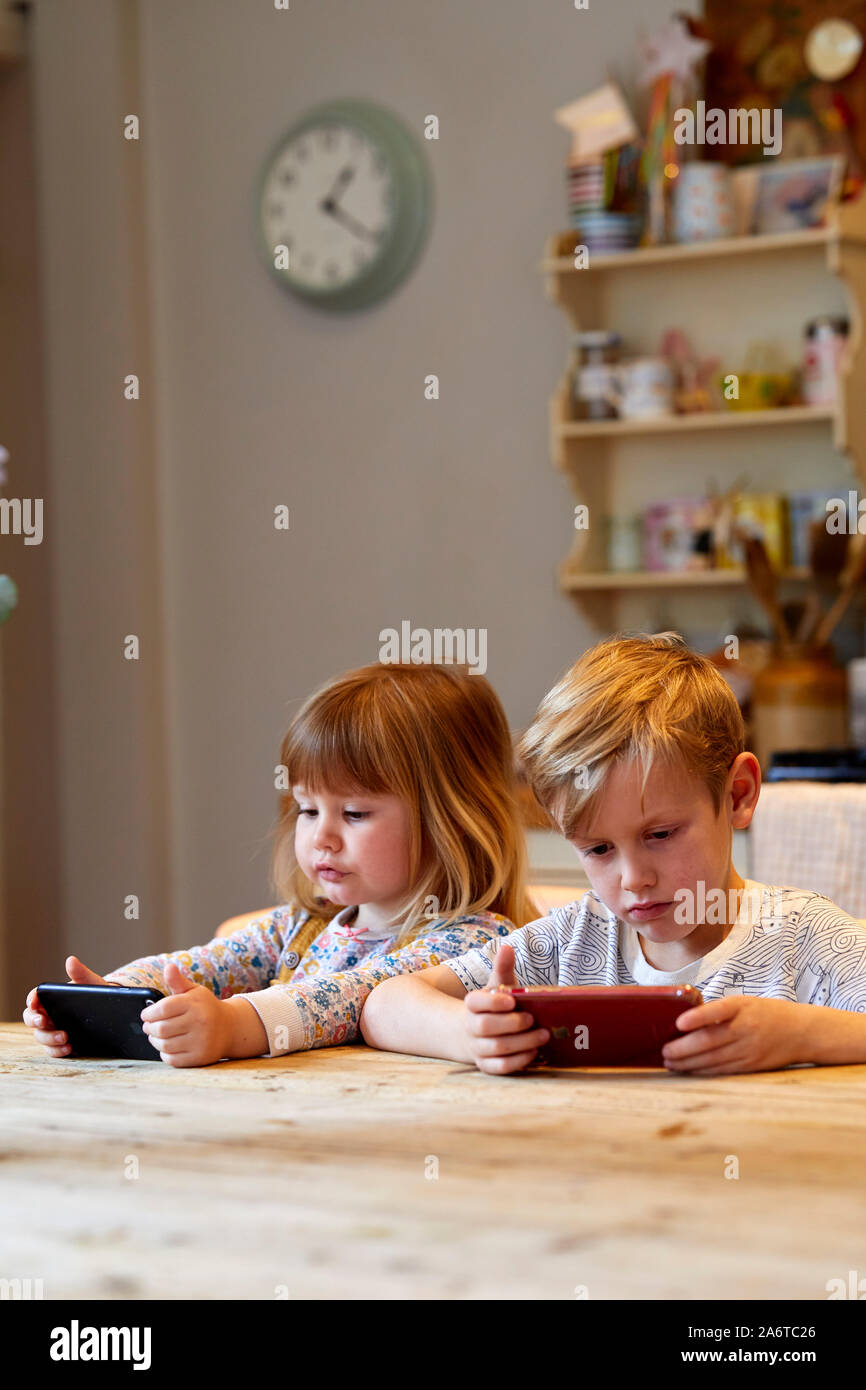 Children playing on devices Stock Photo - Alamy