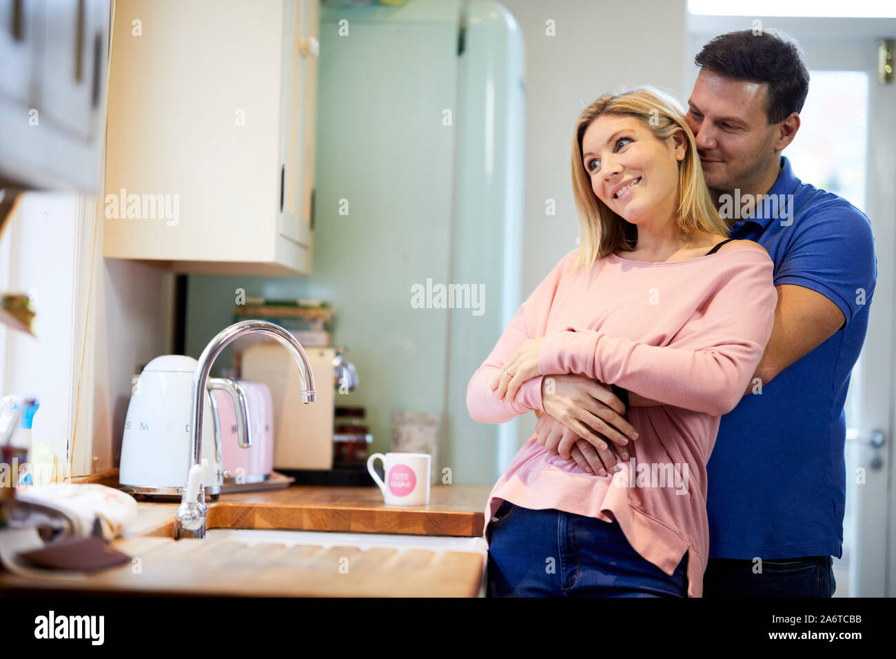 Woman indoors home cuddling hi-res stock photography and images - Alamy