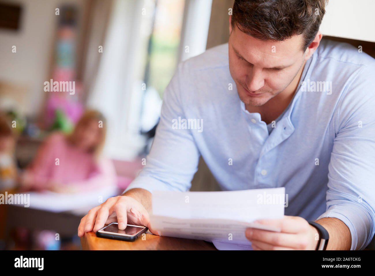 Man looking through his bills Stock Photo - Alamy