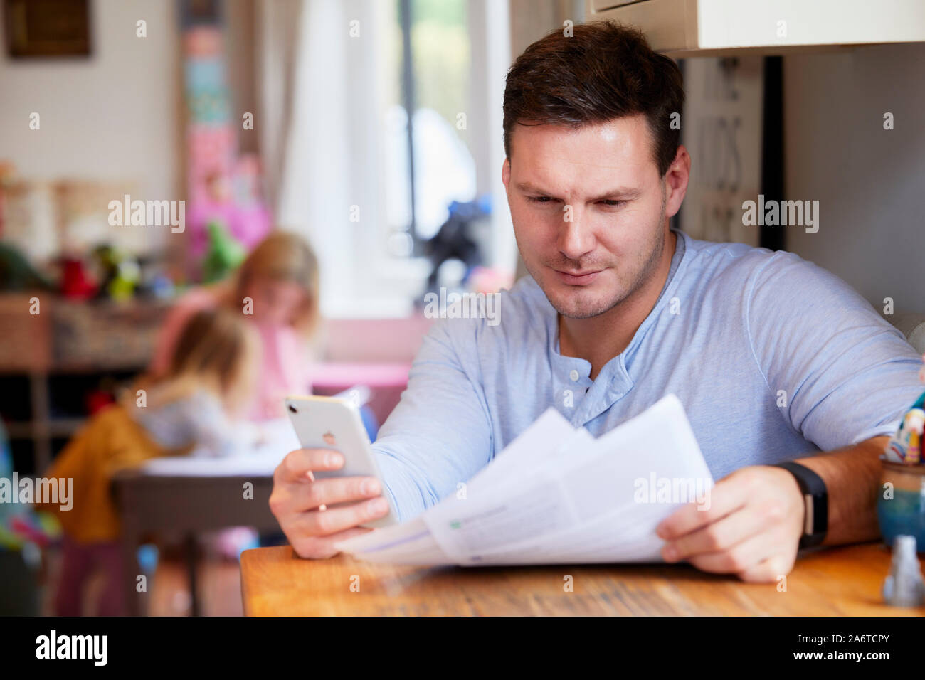 Man looking through his bills Stock Photo - Alamy