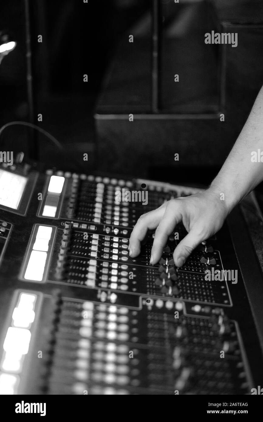 The sound engineer at work behind a mixing console at a concert Stock ...