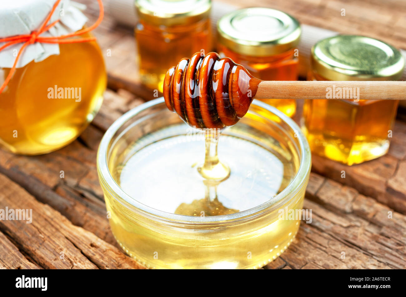 Honey dripping from honey dipper Stock Photo - Alamy