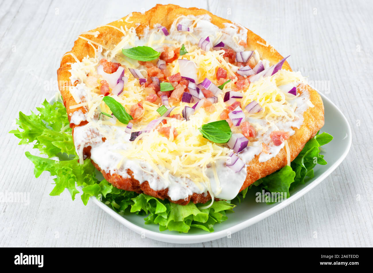 Langos with bacon and cheese - Hungarian fried dough food Stock Photo ...