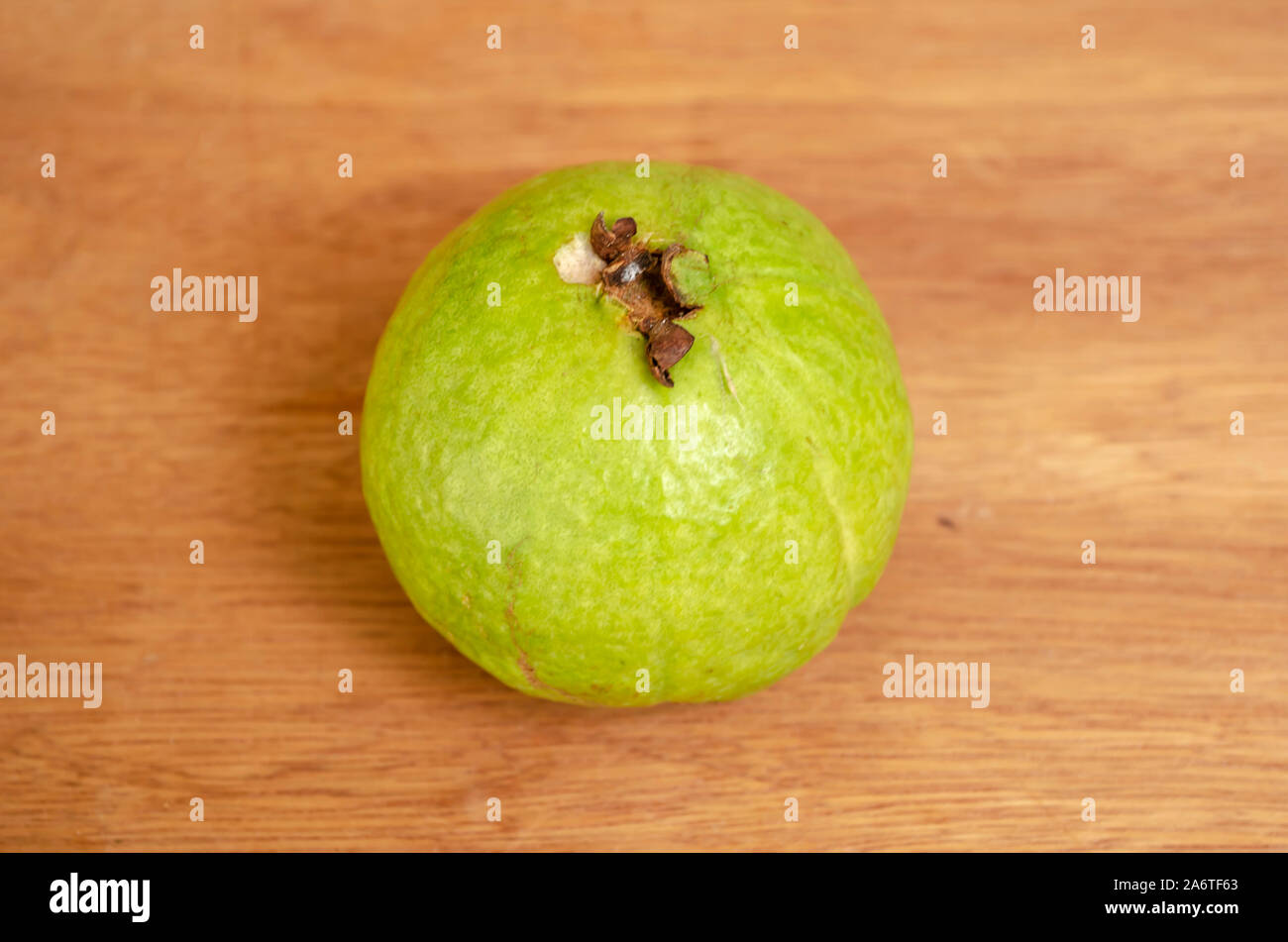 Top Of Round Guava On Board Surface Stock Photo - Alamy