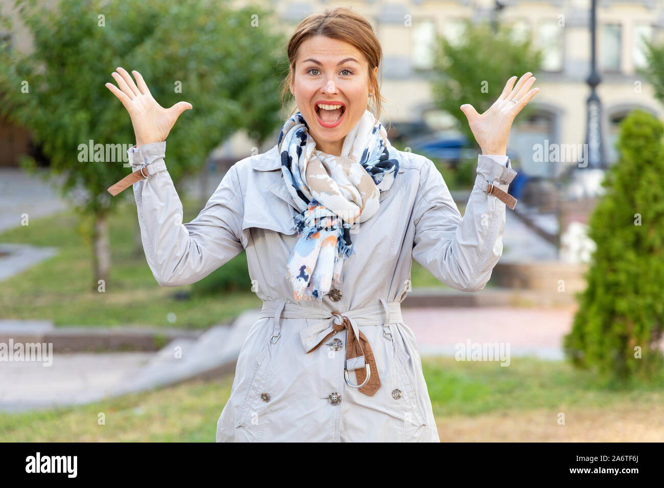 Beautiful surprised middle-aged woman standing against the backdrop of ...