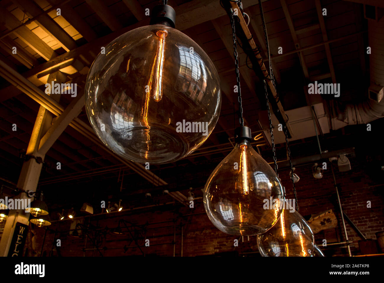 vintage large hanging glass lightbulbs with orange glow Stock Photo - Alamy
