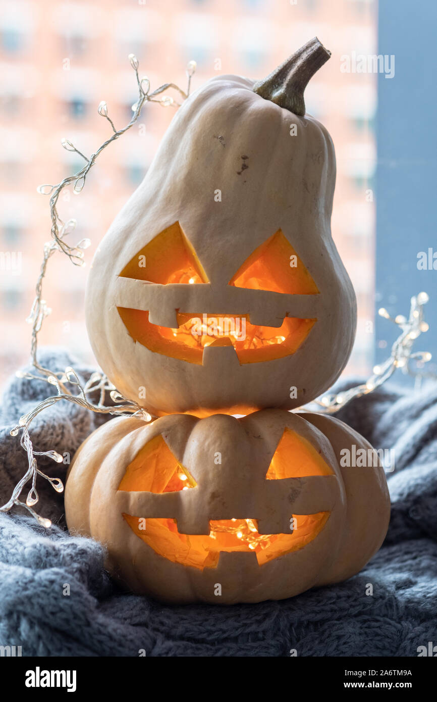 Jack o lanterns Halloween pumpkins face on a window Stock Photo - Alamy