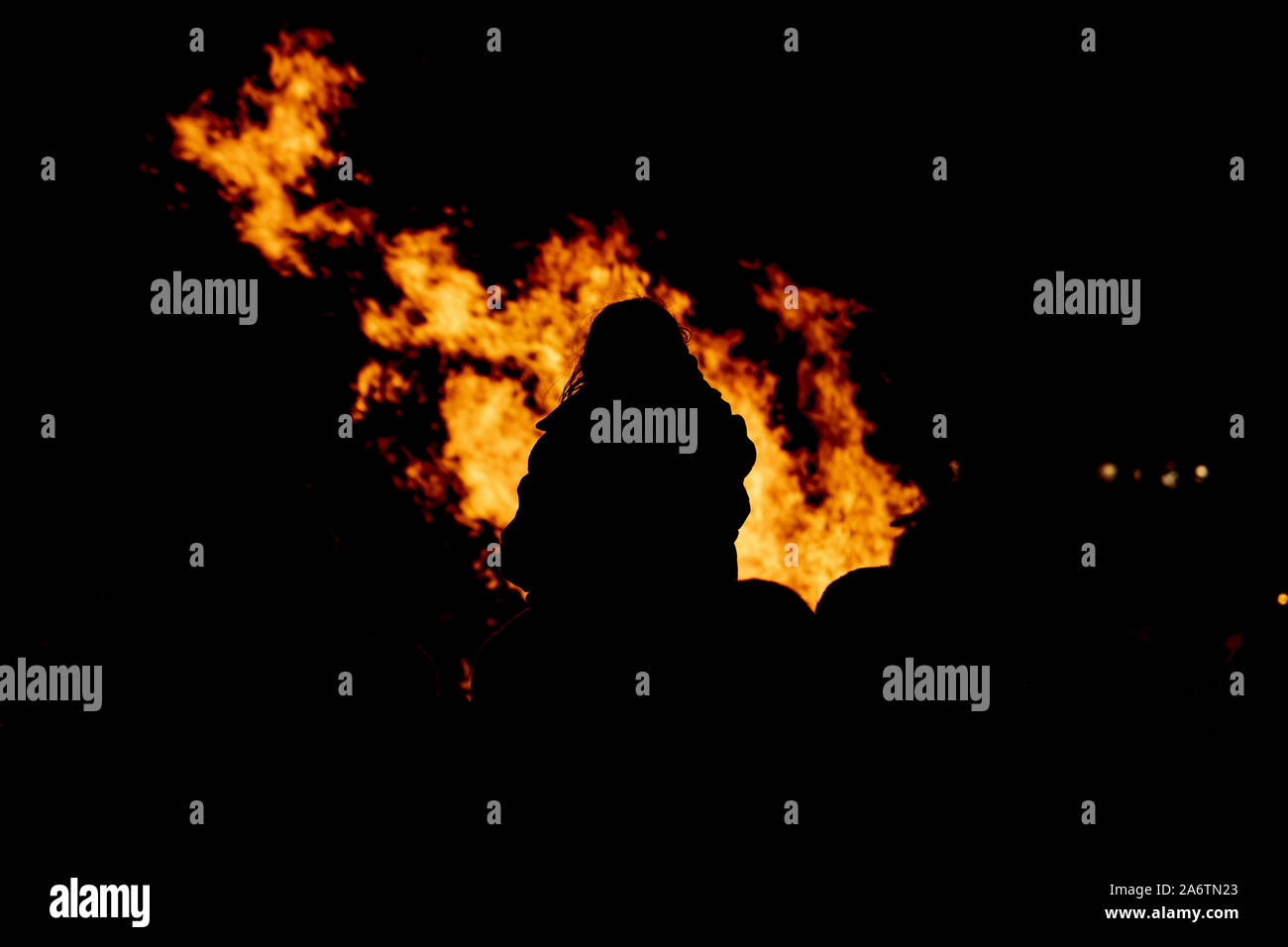 People watching fire burning at night Stock Photo - Alamy