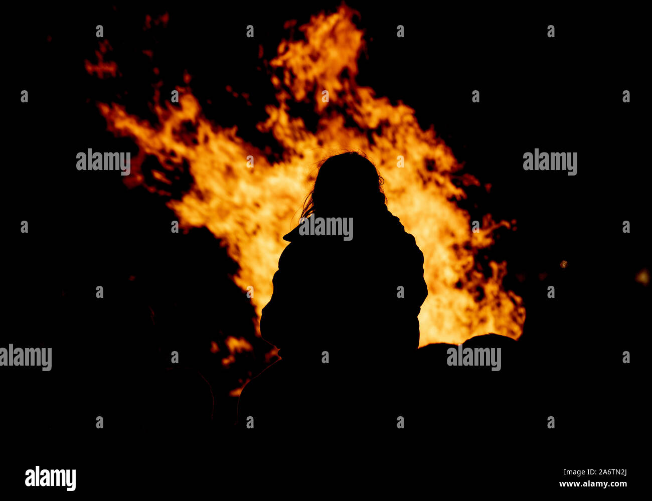 People watching fire burning at night Stock Photo - Alamy