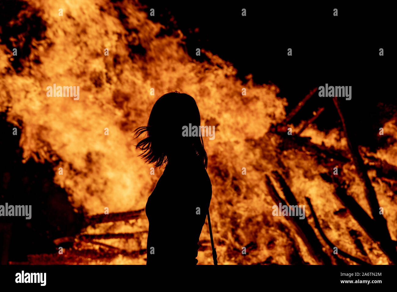 People watching fire burning at night Stock Photo - Alamy