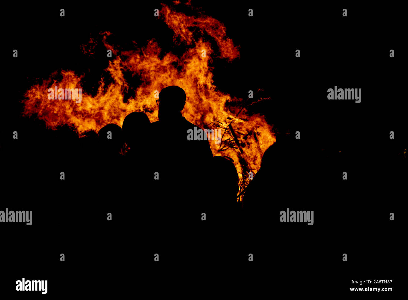 People watching fire burning at night Stock Photo - Alamy