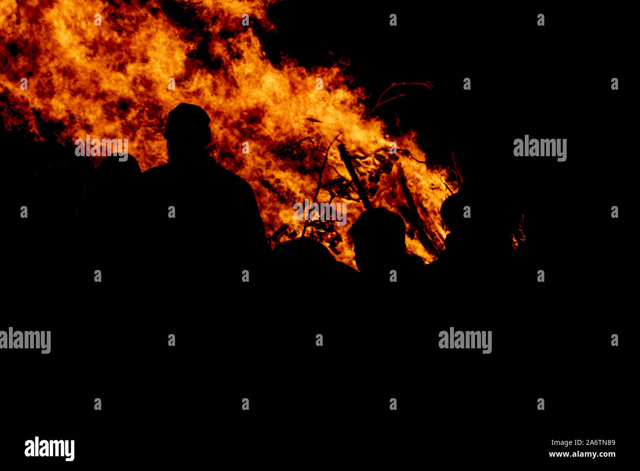 People watching fire burning at night Stock Photo - Alamy
