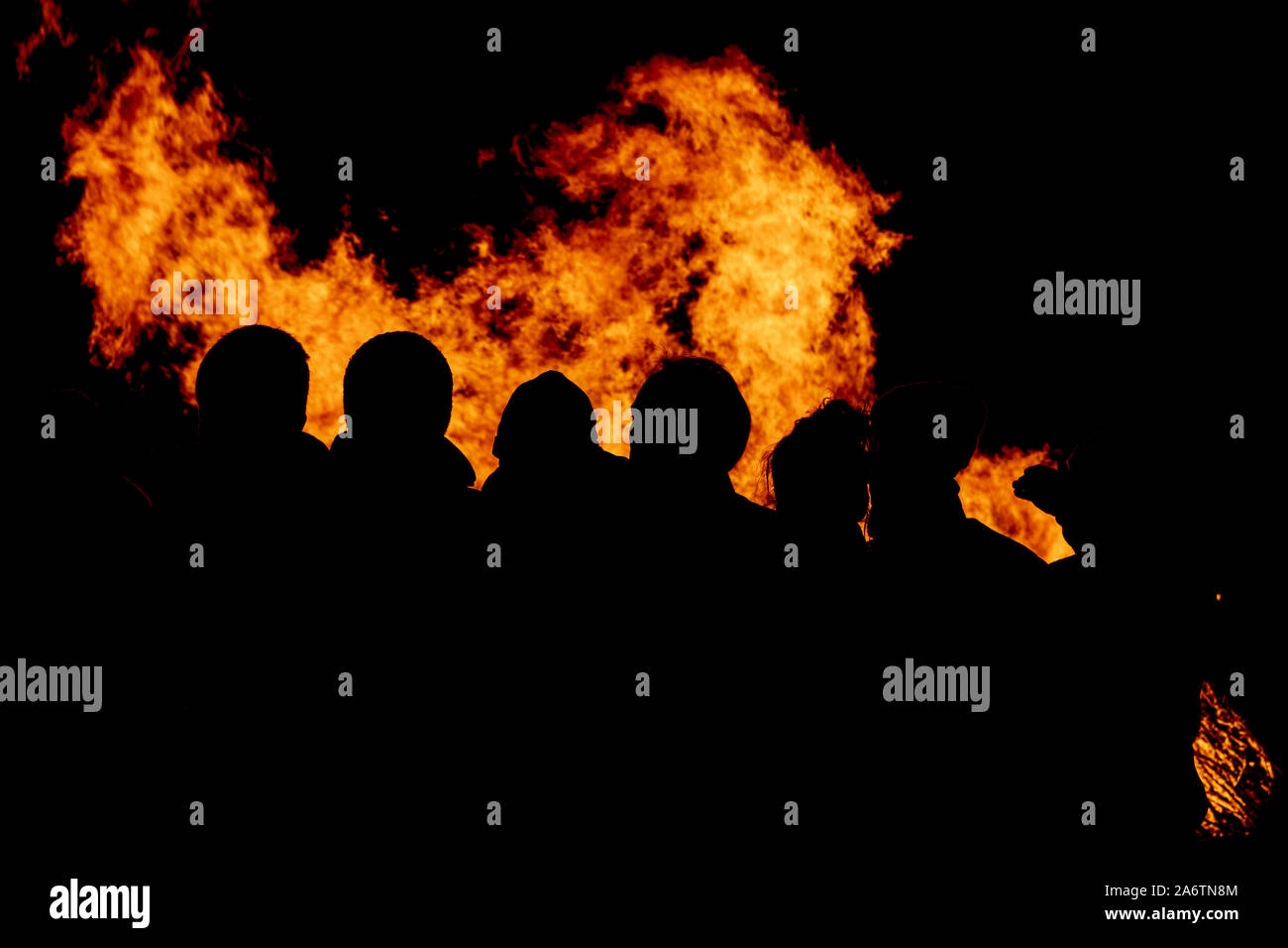 People watching fire burning at night Stock Photo - Alamy