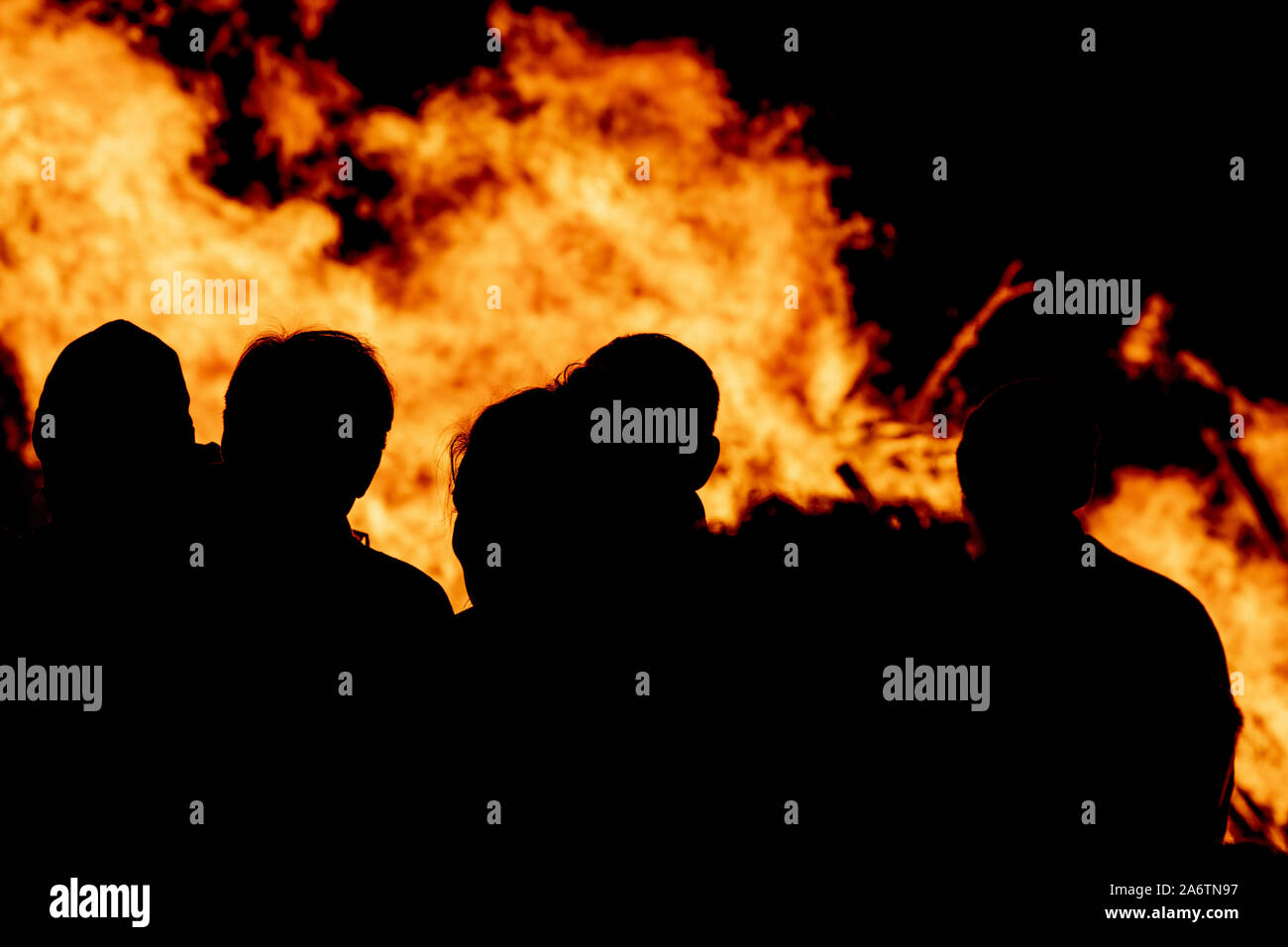 People watching fire burning at night Stock Photo - Alamy
