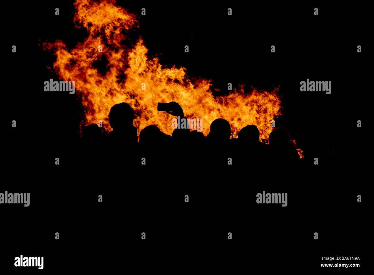 People watching fire burning at night Stock Photo - Alamy