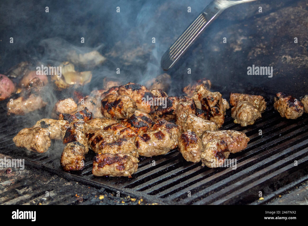 Small kebabs (pork and veal mince, typical Balkan cuisine) grilled in a ...