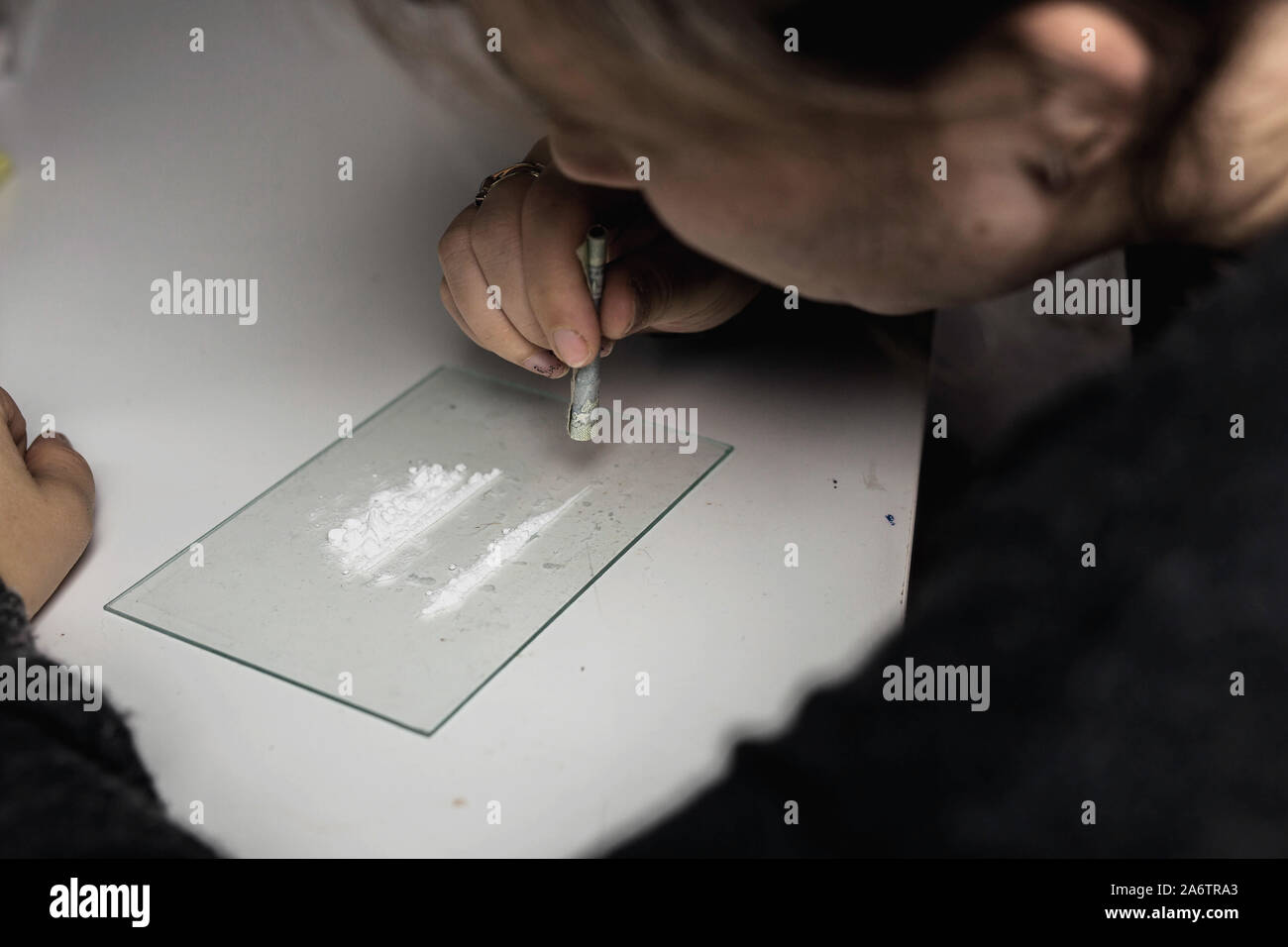 Young woman snorting drugs, cocaine or speed or other drugs abuse ...