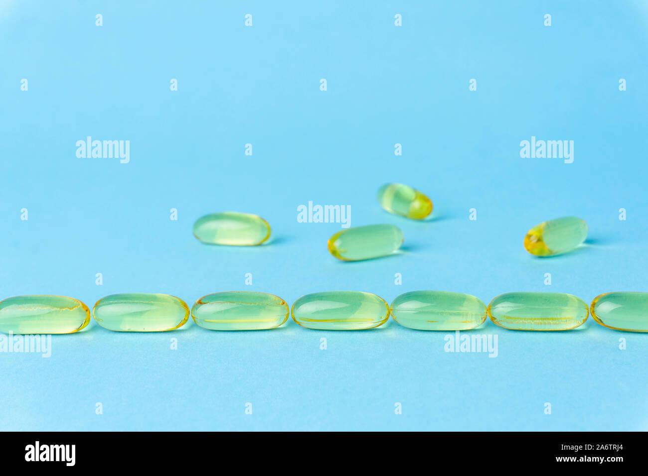Fish oil capsules blue table hi-res stock photography and images - Alamy