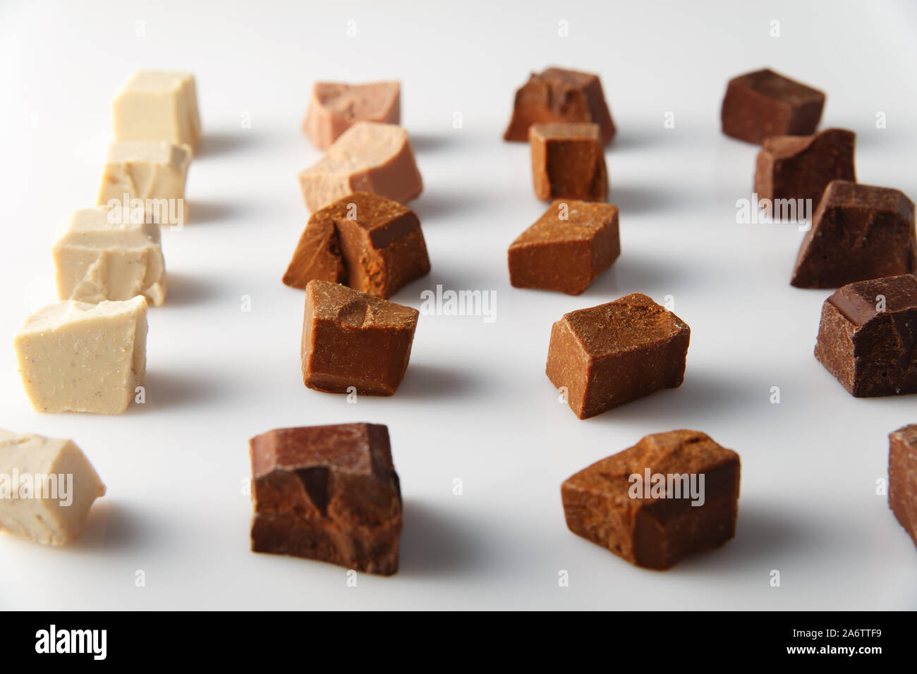 Pieces of different milk chocolate on white background Stock Photo - Alamy