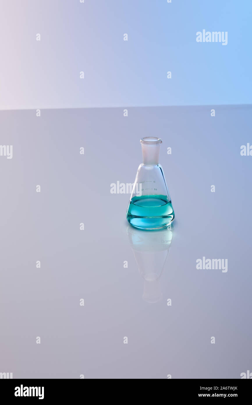 glass flask with blue colorful liquid Stock Photo - Alamy