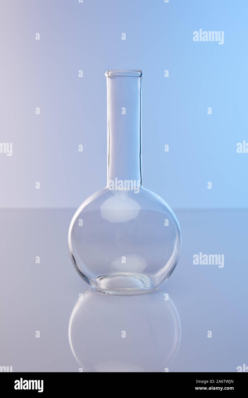 empty clean glass flask on blue background Stock Photo - Alamy