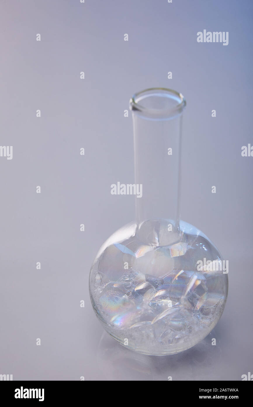 glass flask with bubbles on grey background Stock Photo - Alamy