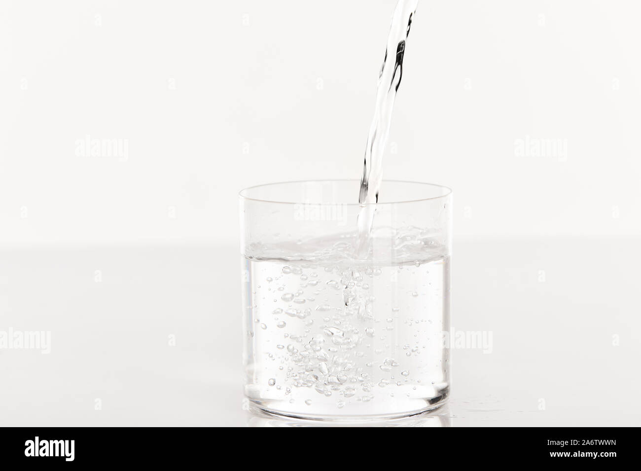 clear fresh water pouring into glass isolated on white Stock Photo - Alamy