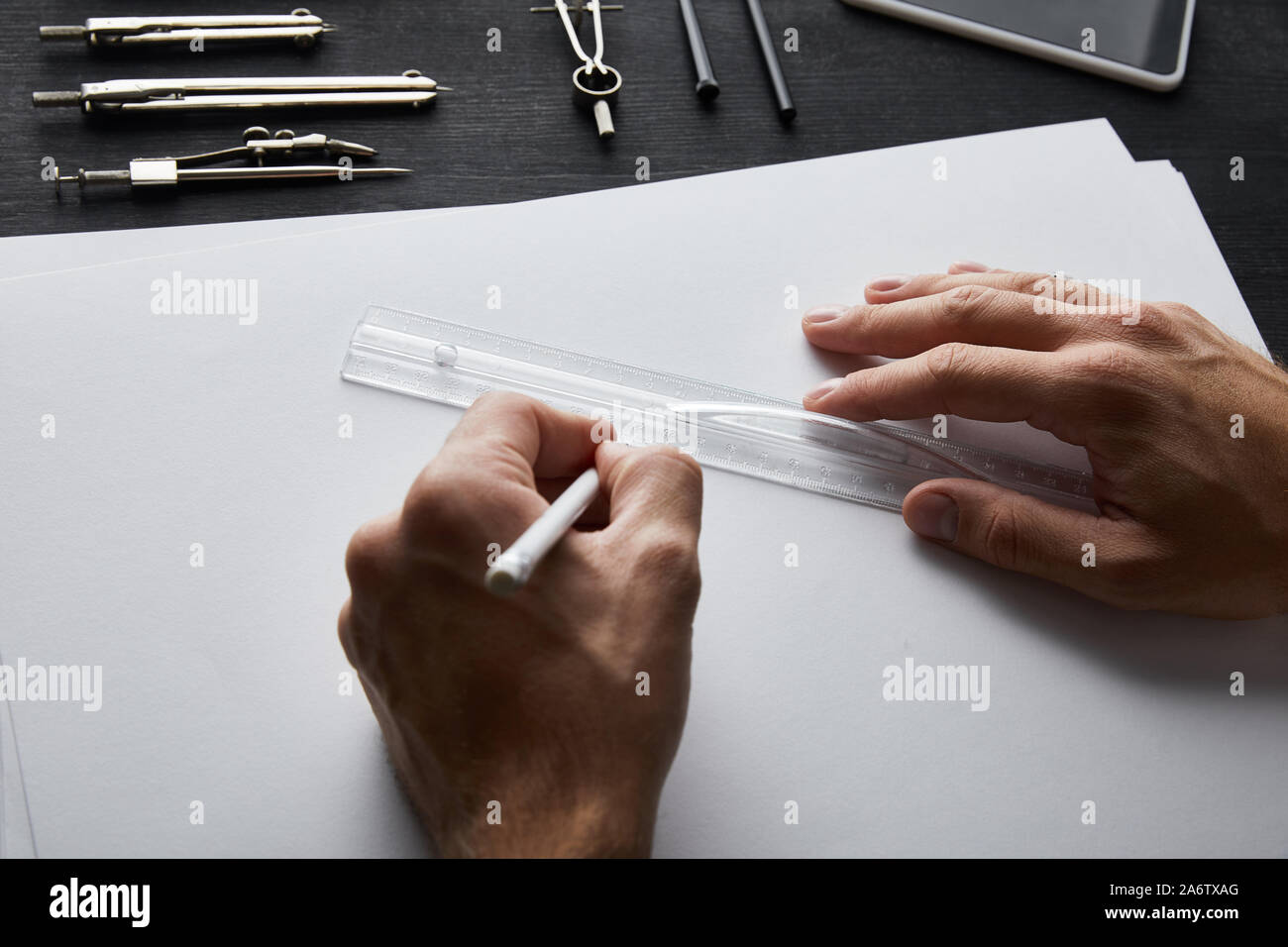 cropped view of architect drawing with pencil and ruler Stock Photo - Alamy