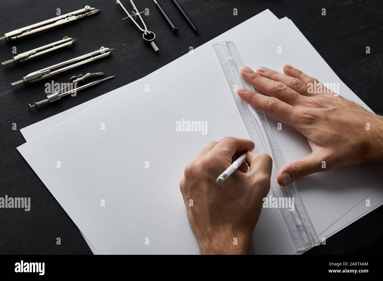 cropped view of architect drawing with pencil and ruler Stock Photo - Alamy