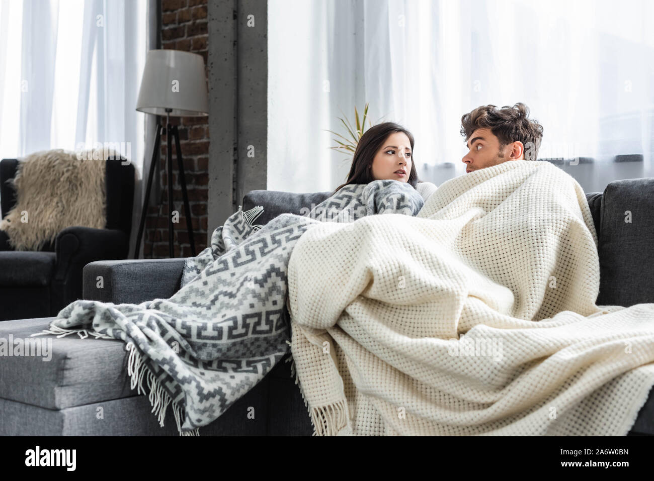 attractive girlfriend and boyfriend covered with blankest and feeling ...