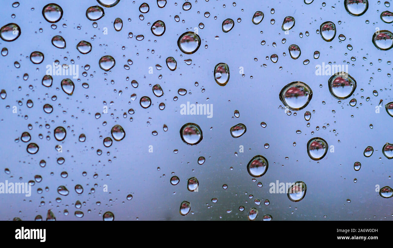 water or rain droplets on glass window. selective focus. narrow depth ...