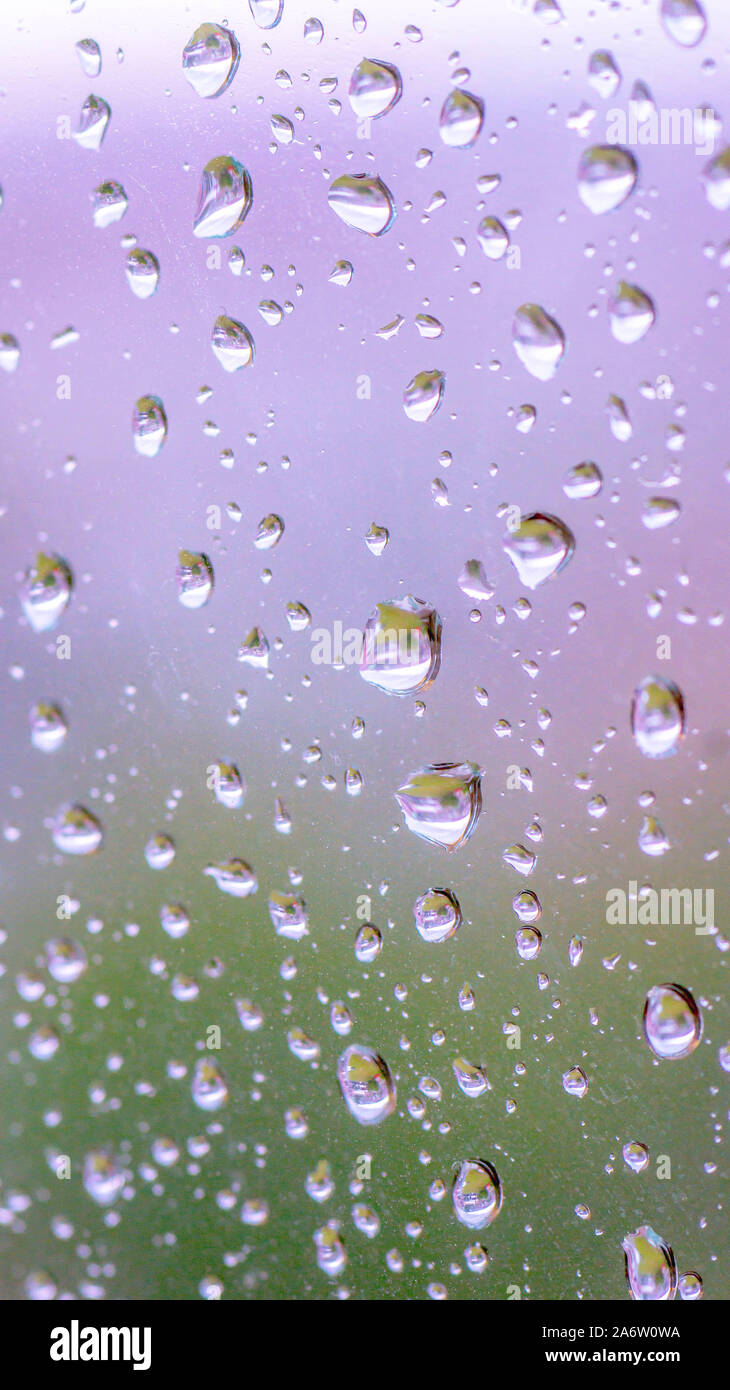 water or rain droplets on glass window. selective focus. narrow depth ...