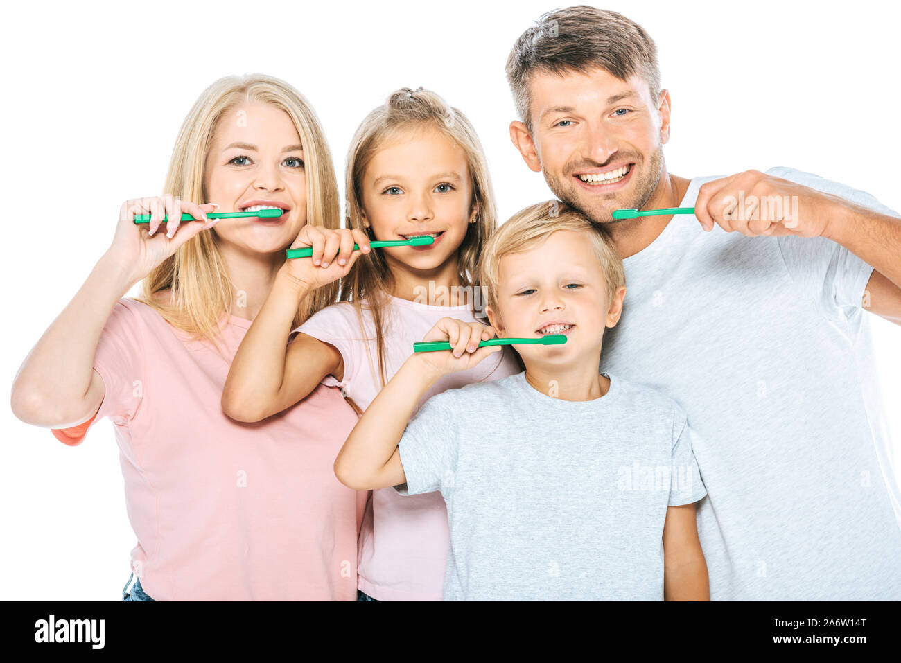 happy parents and children holding toothbrushes while brushing teeth ...