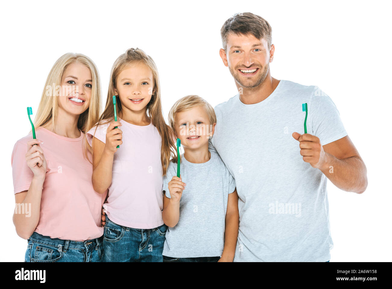 happy parents and kids holding toothbrushes isolated on white Stock ...