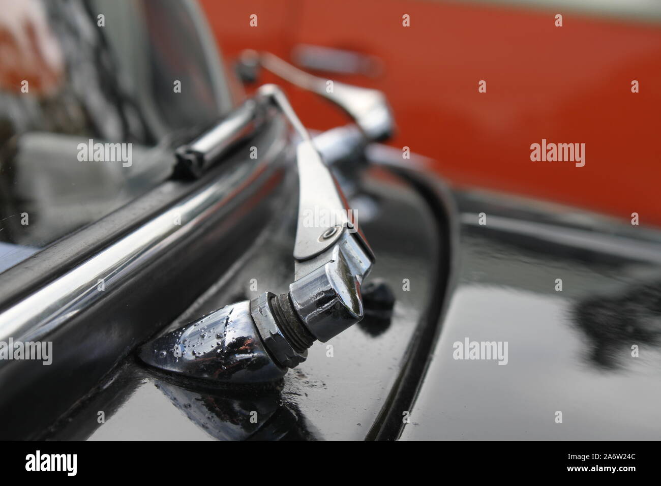 The chrome hub for a window wiper on a classic car Stock Photo - Alamy
