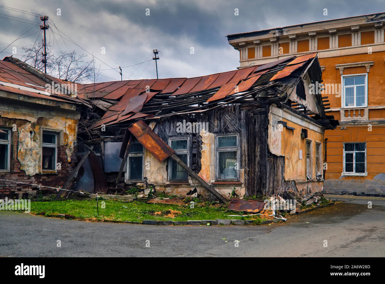 A fragment of an old collapsing building on a background of cloudy sky ...
