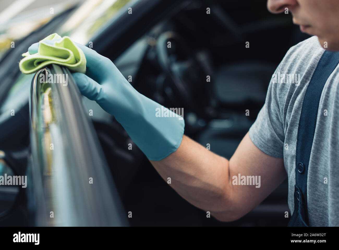 partial view of car cleaner wiping steering wheel with rag Stock Photo ...