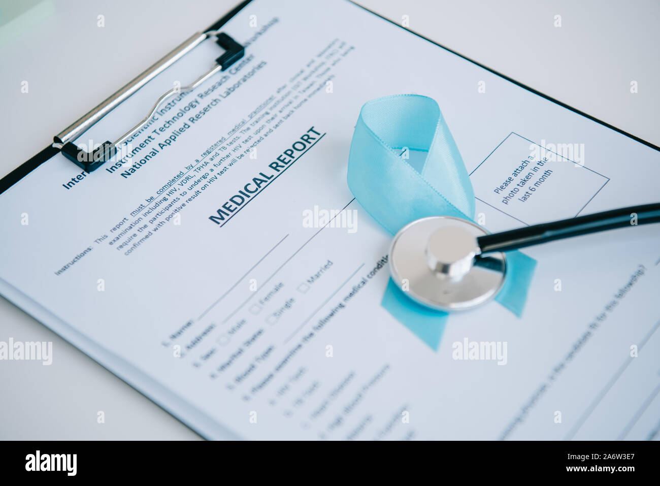 blue awareness ribbon and stethoscope on medical report Stock Photo - Alamy