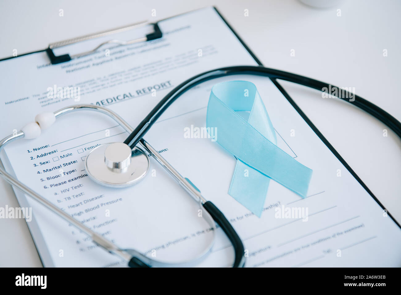 medical report, stethoscope and blue awareness ribbon on white table ...