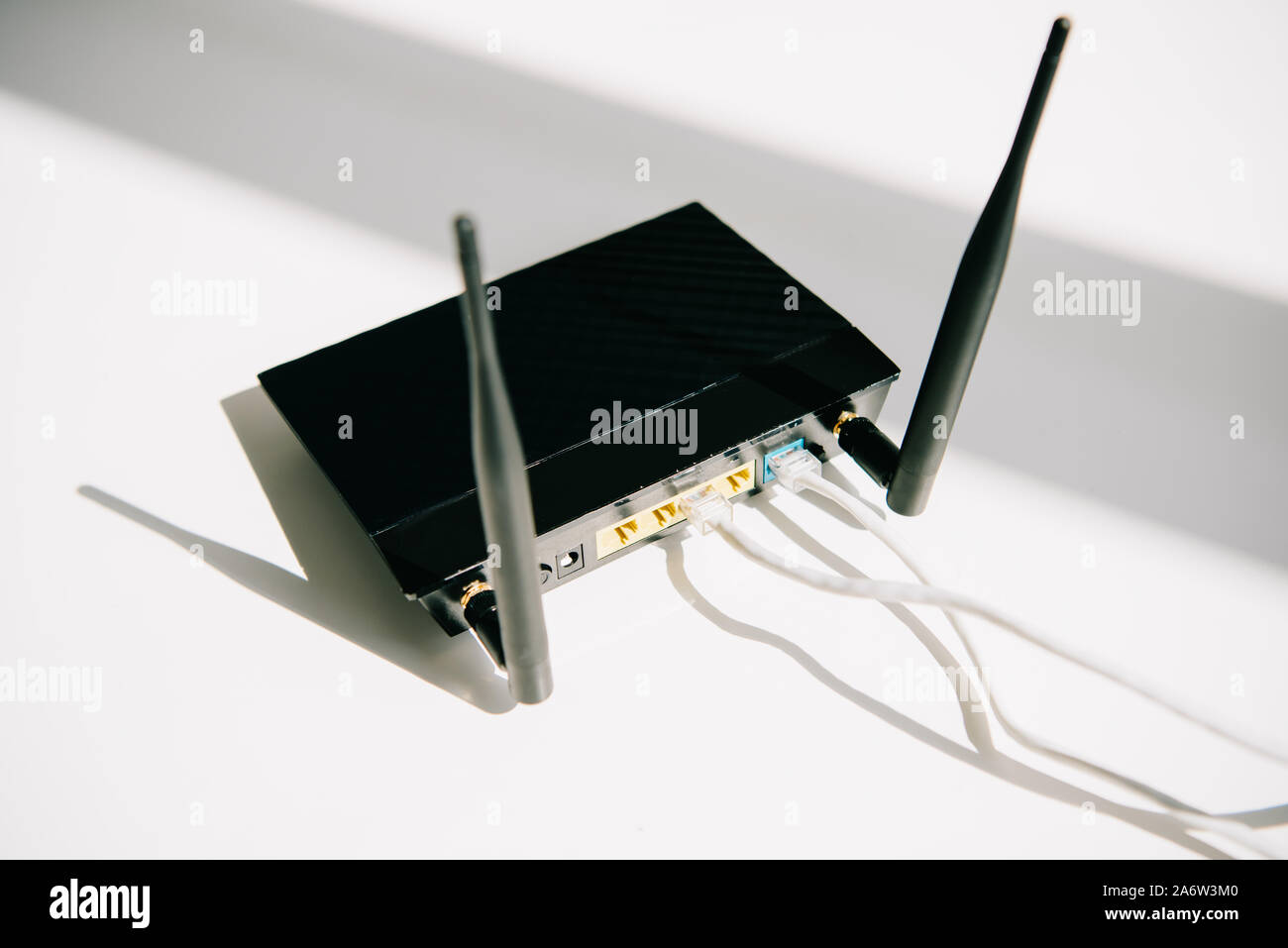 black plugged router on white office table in sunshine Stock Photo - Alamy