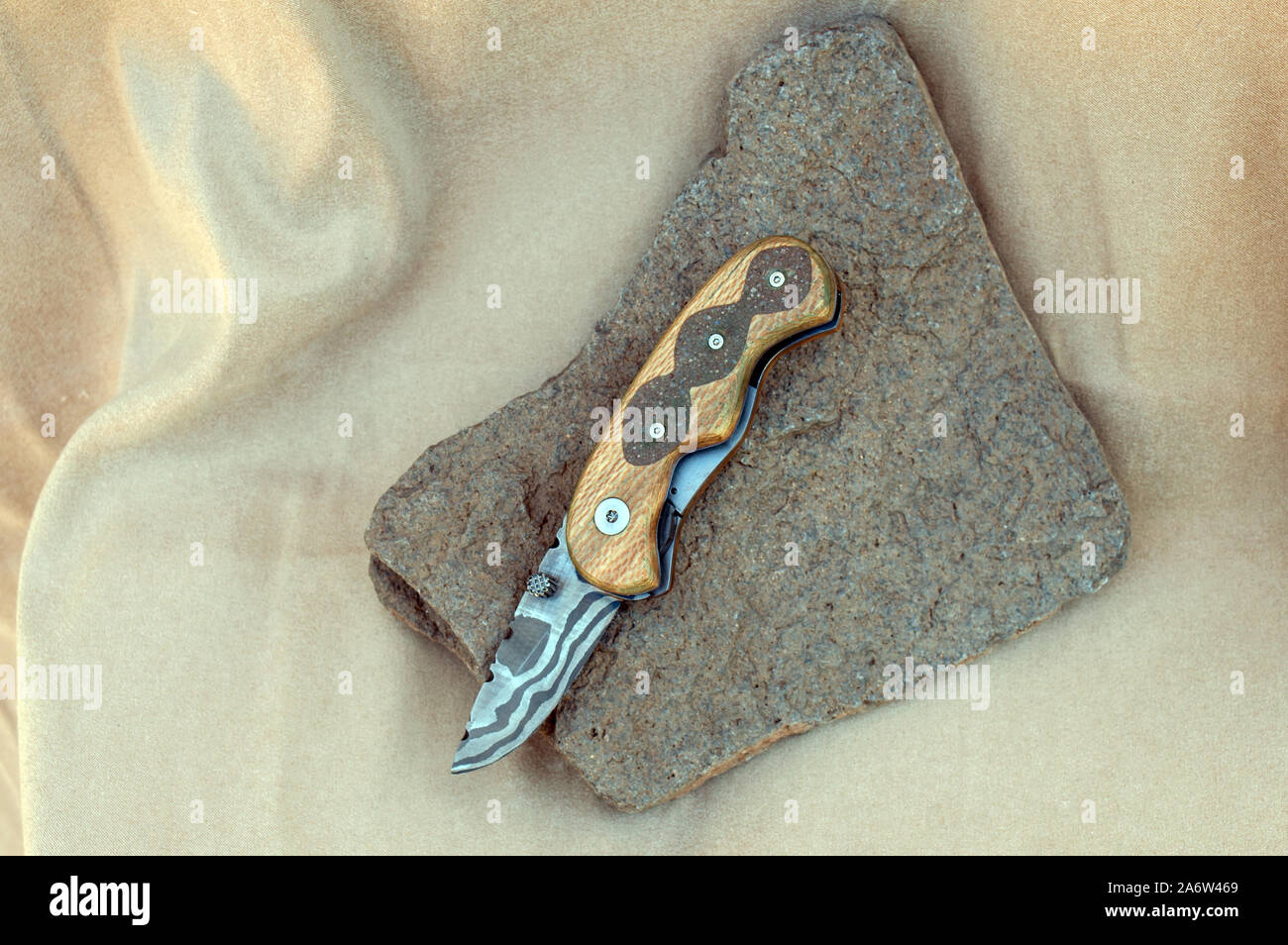 A beautiful liner lock knife with sycamore handle and quartz inlay ...