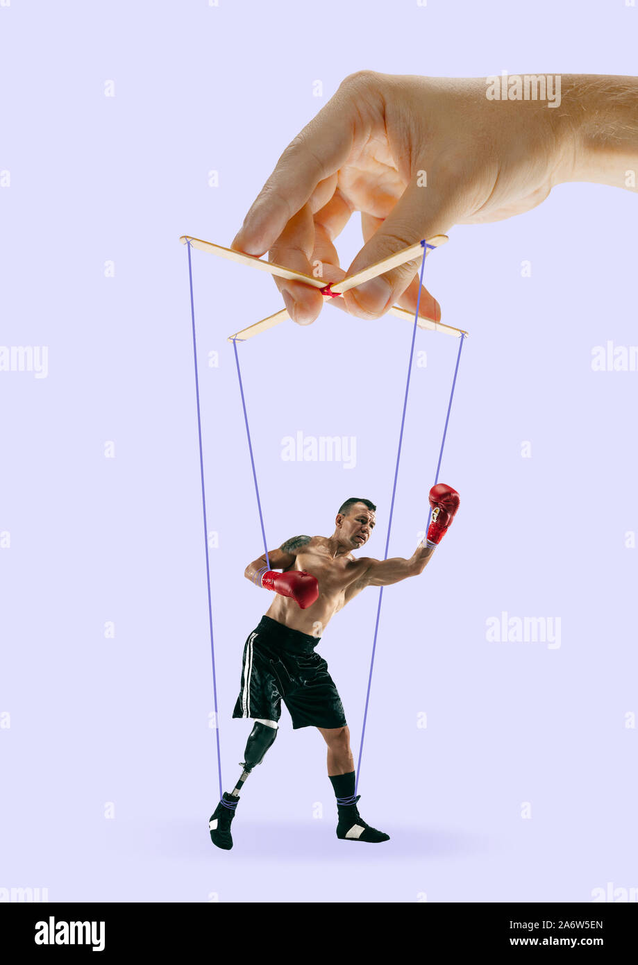 Man like a puppet in somebodies hands on purple background. Concept of ...