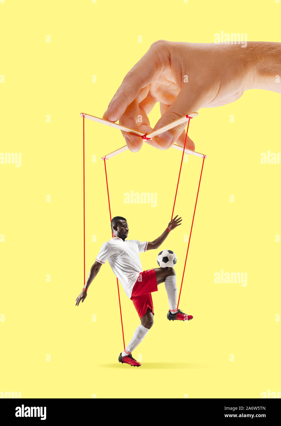Man like a puppet in somebodies hands on yellow background. Concept of ...
