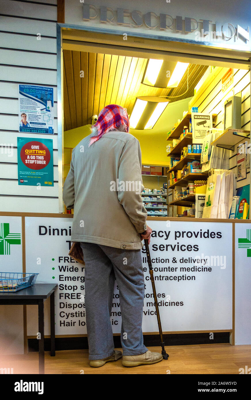 old lady waiting at the counter in a chemist Stock Photo - Alamy