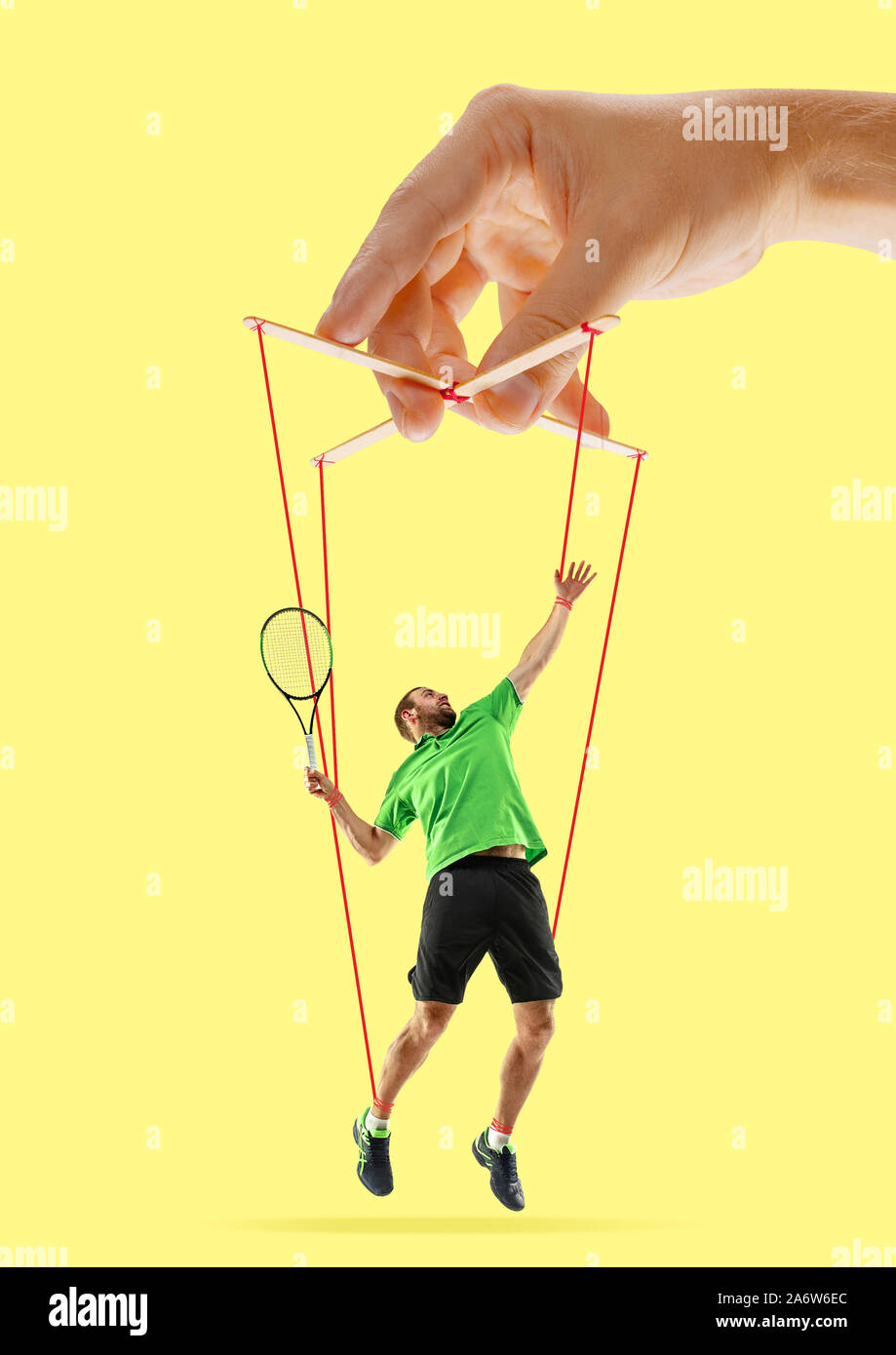 Man like a puppet in somebodies hands on yellow background. Concept of ...