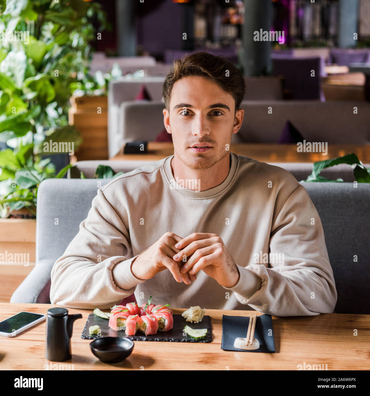 Handsome man eating sushi hi-res stock photography and images - Alamy