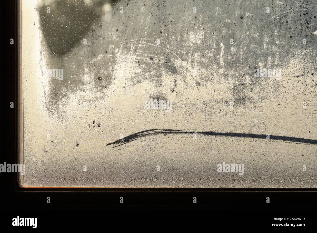 Part of a window covered with condensed water in the sunlight of an ...