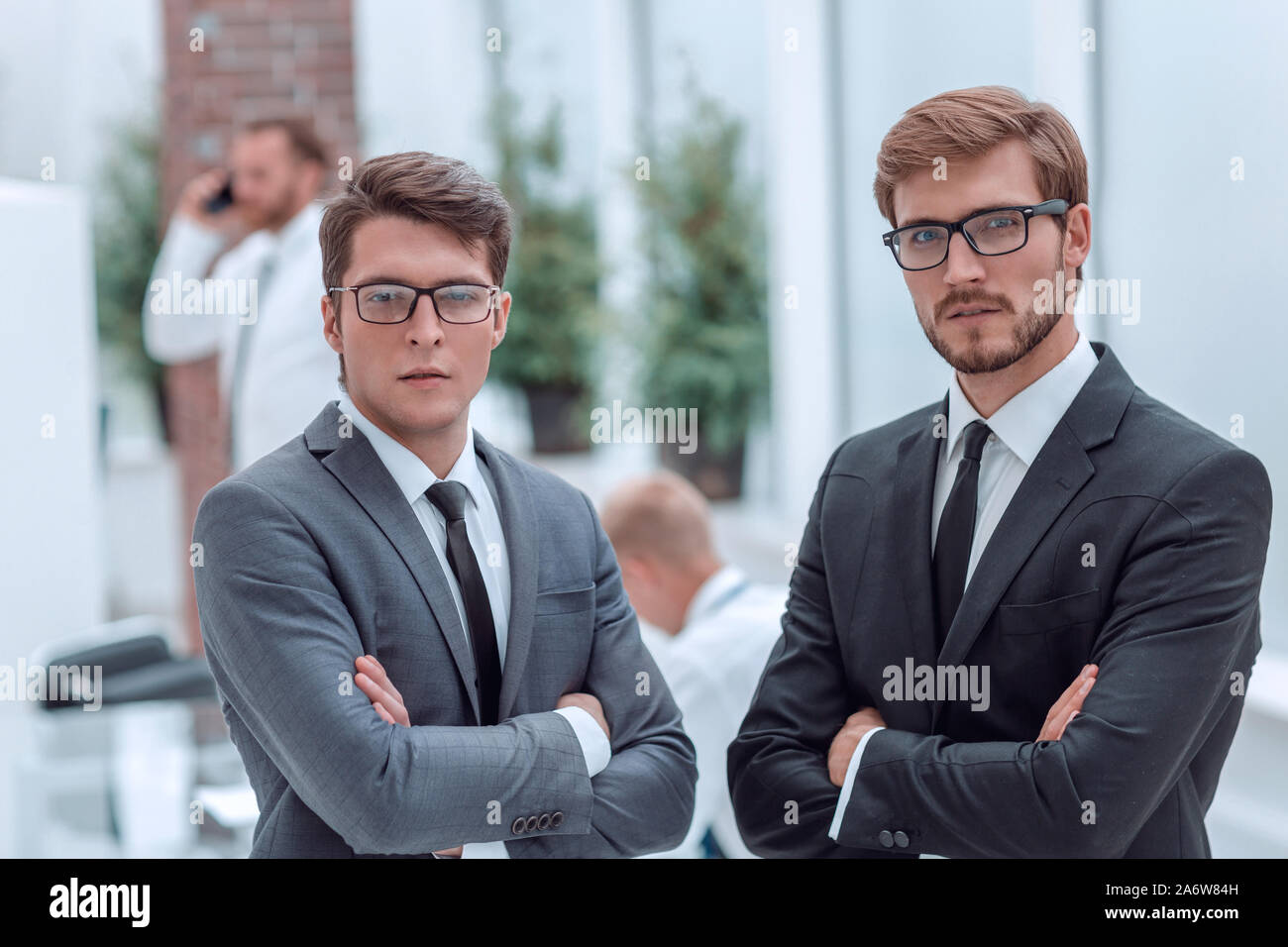 close up. two happy business partners standing in the office Stock Photo - Alamy